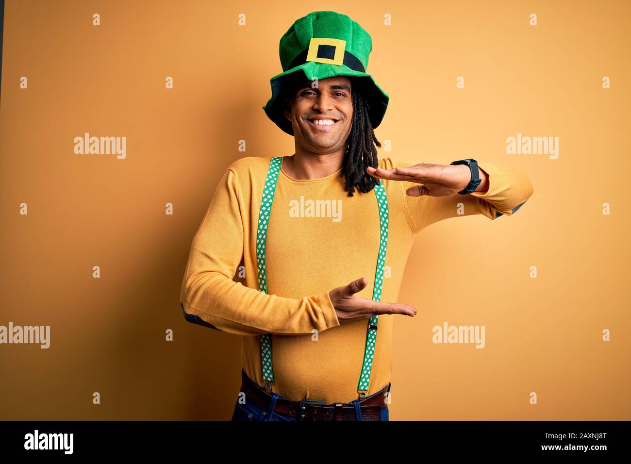 Young african american man wearing green hat celebrating saint patricks ...