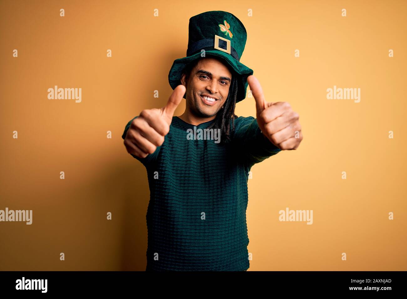 Young african american man wearing green hat with clover celebrating ...