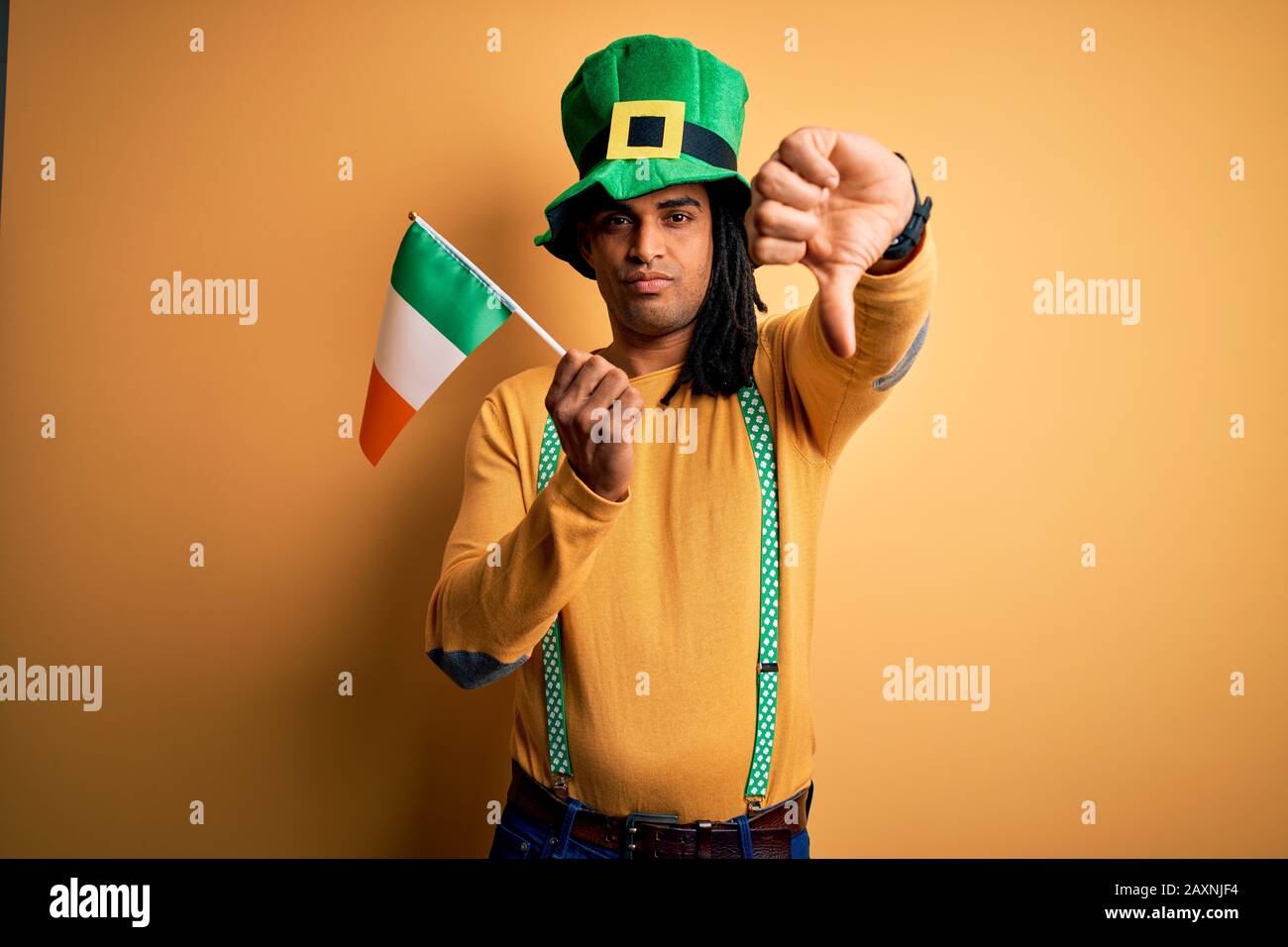 African american man wearing green hat holding irish ireland flag ...