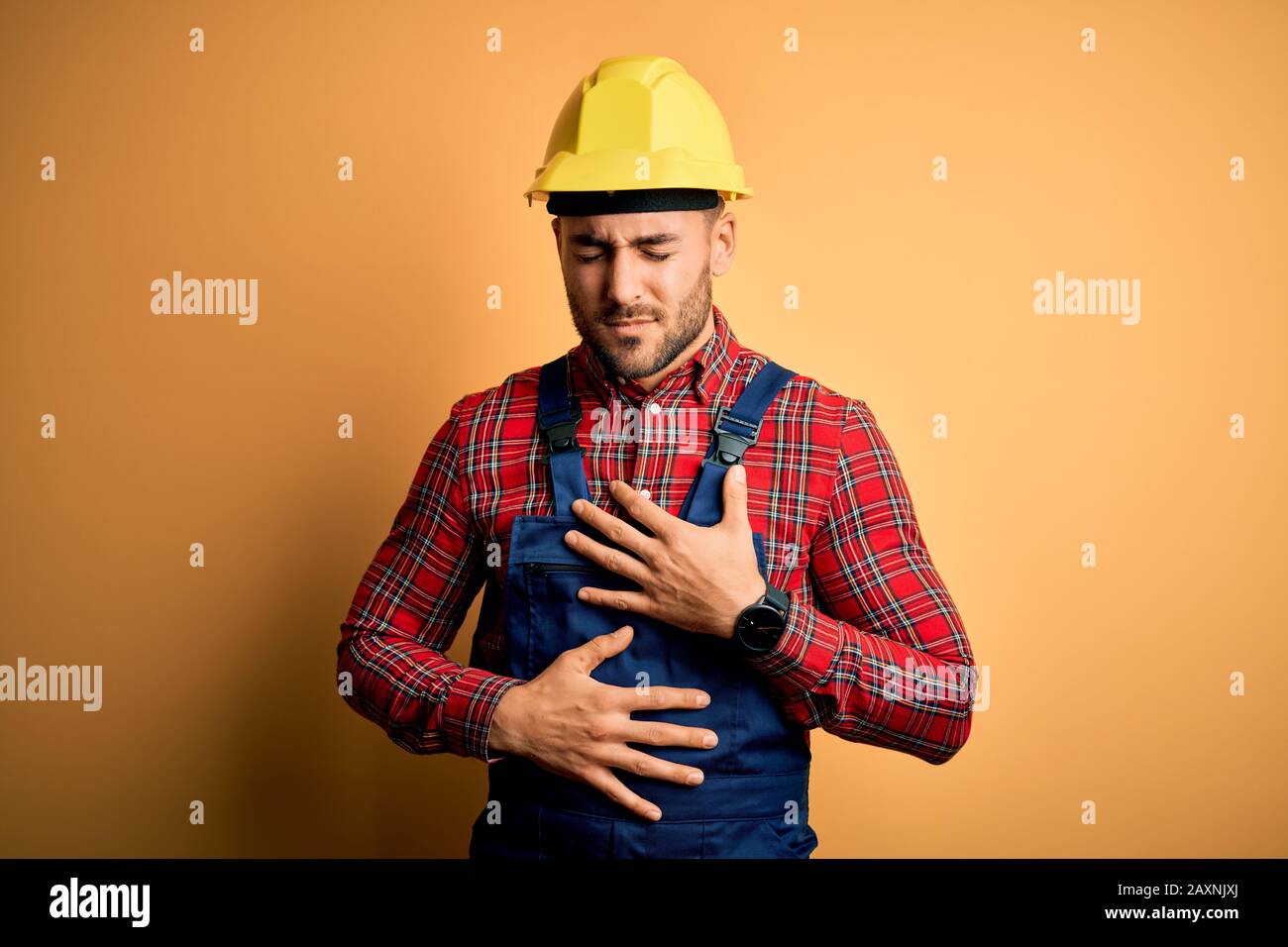 Young builder man wearing construction uniform and safety helmet over ...