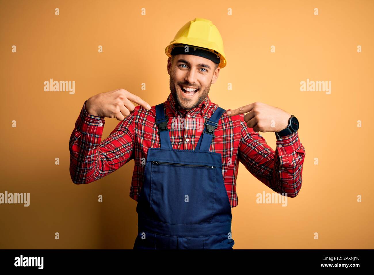 Young builder man wearing construction uniform and safety helmet over ...