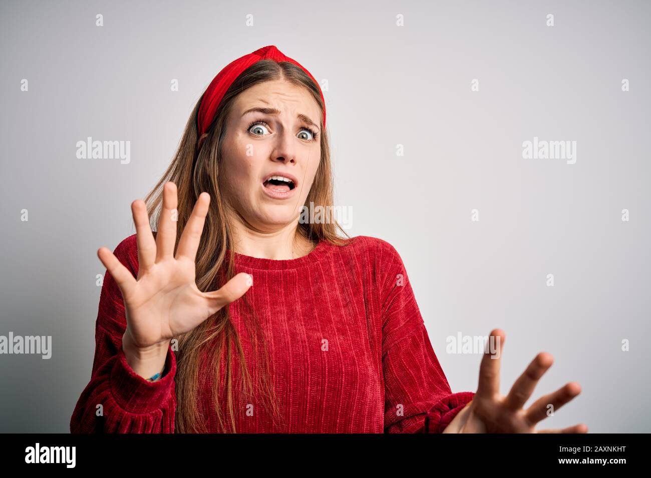 Young beautiful redhead woman wearing red casual sweater and diadem ...