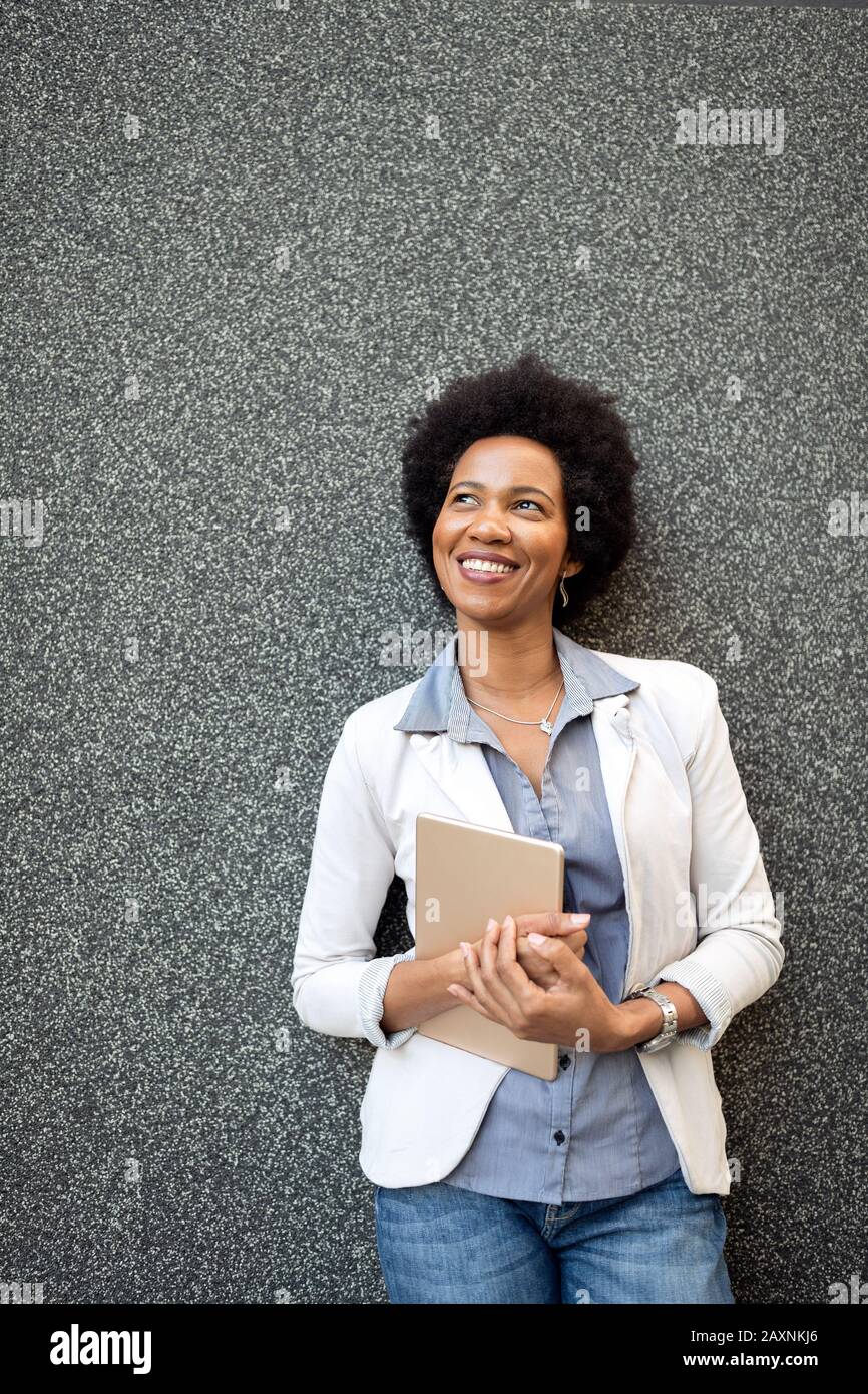 Beautiful happy professional business woman smiling happy with tablet ...