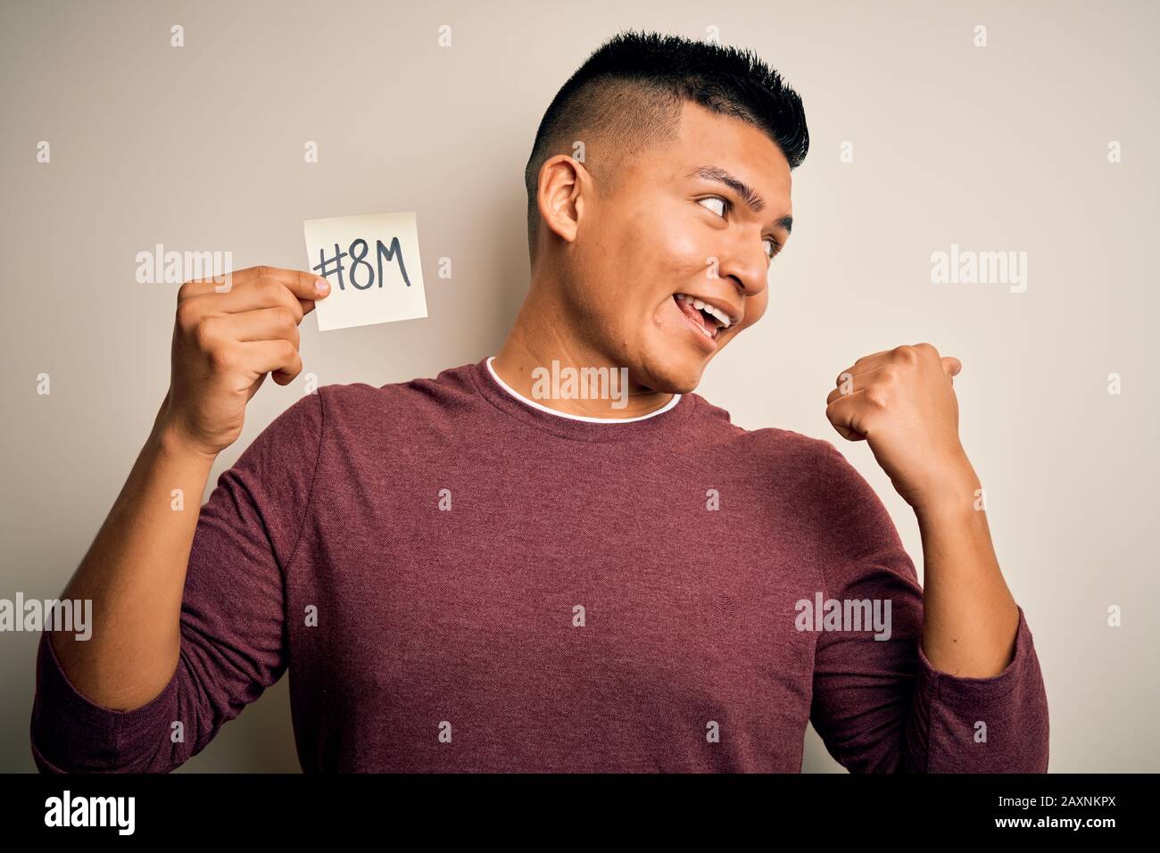 Young handsome latin man celebrating 8th march womens day holding ...