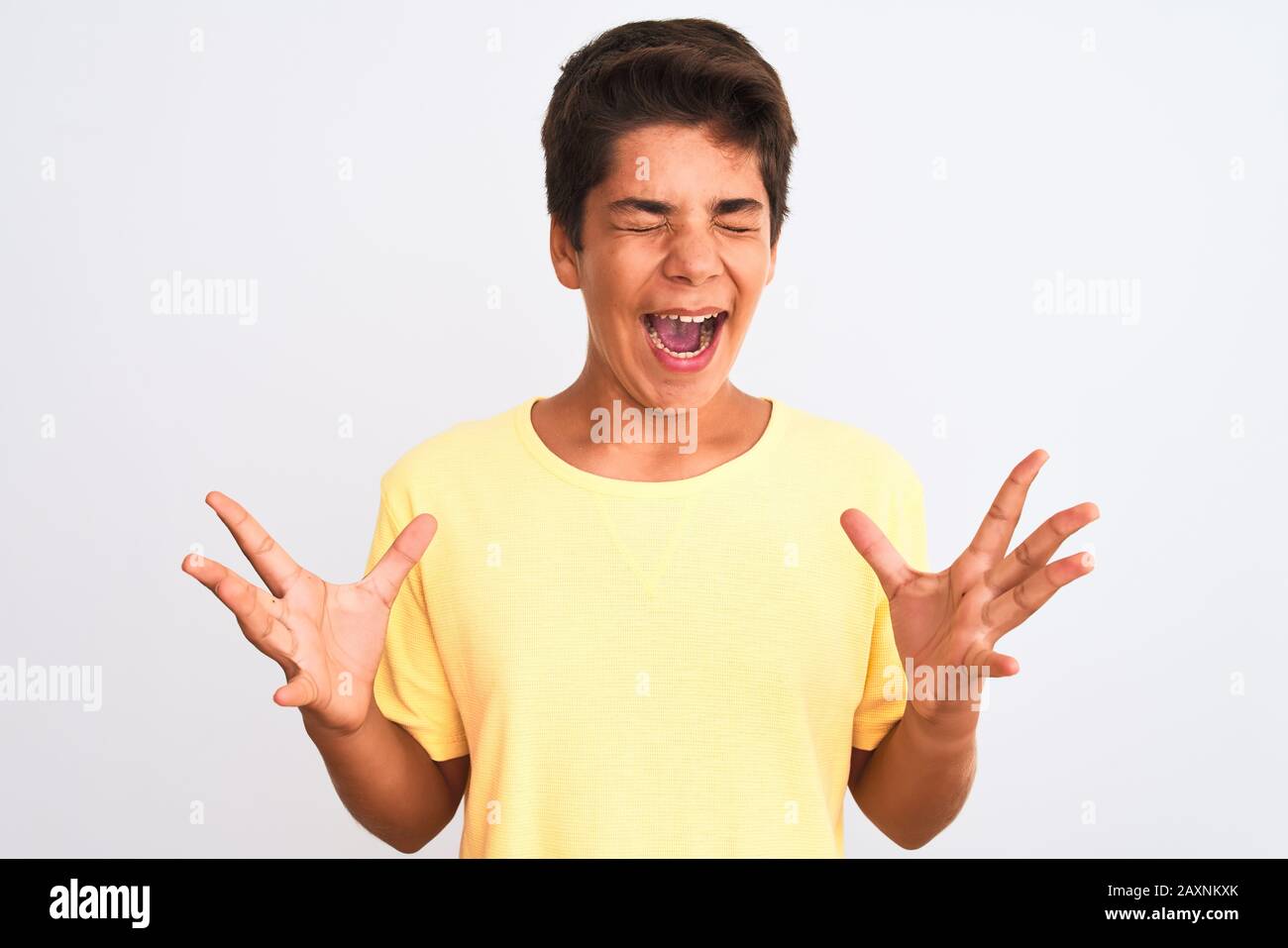 Handsome teenager boy standing over white isolated background ...