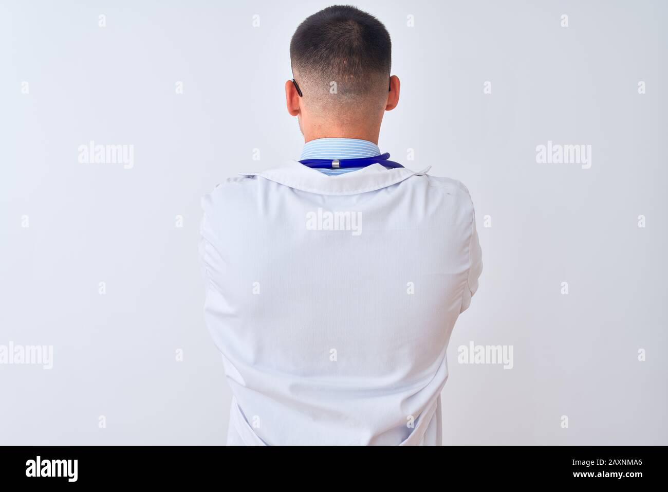 Young doctor man wearing stethoscope over isolated background standing ...