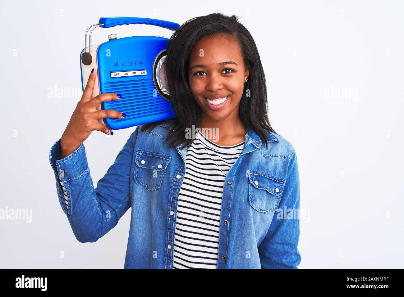 Young african american woman holding vintage retro radio over isolated ...
