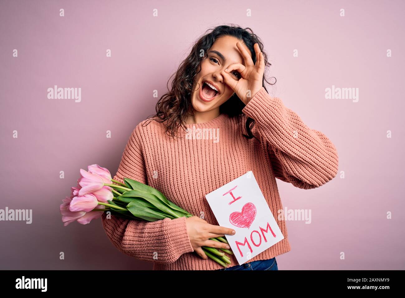 Beautiful curly hair woman holding love mom message and tulips ...