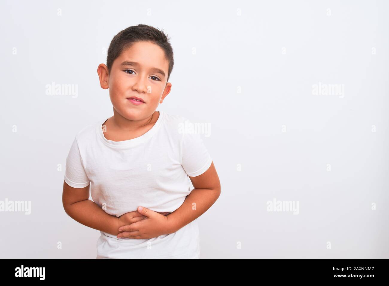Beautiful kid boy wearing casual t-shirt standing over isolated white ...