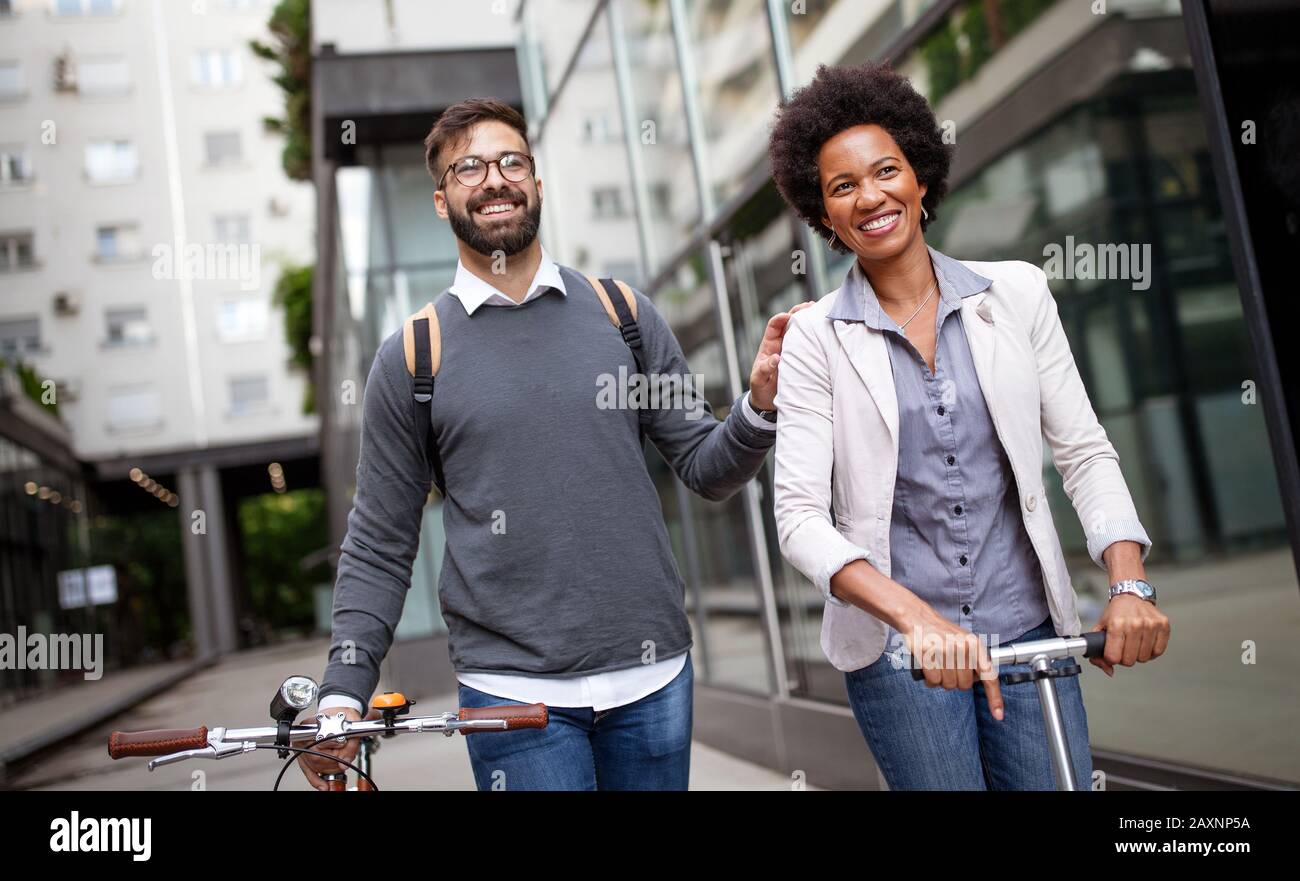 Business people discussing and smiling while walking together outdoor ...