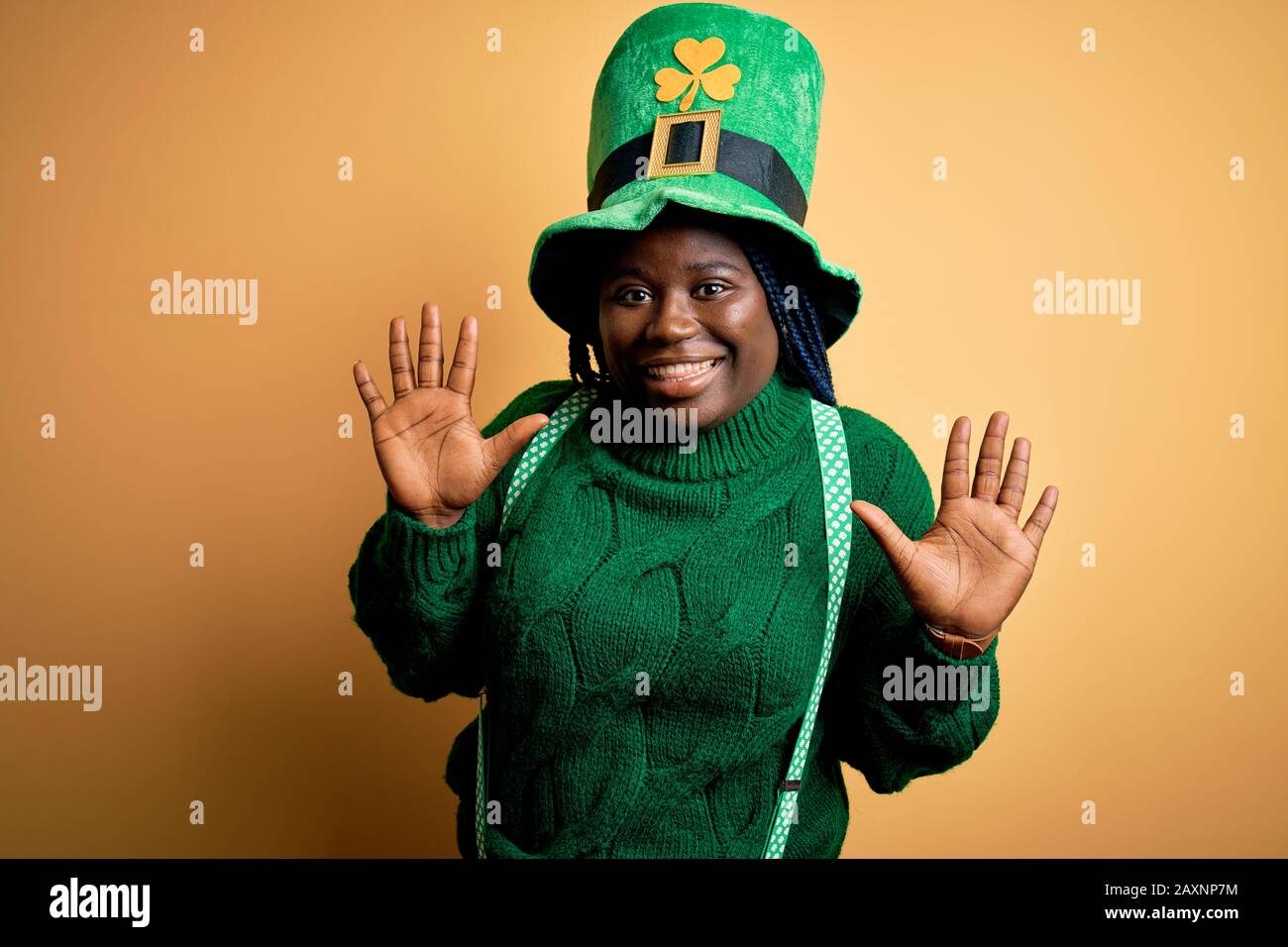 Plus size african american woman with braids wearing green hat with ...