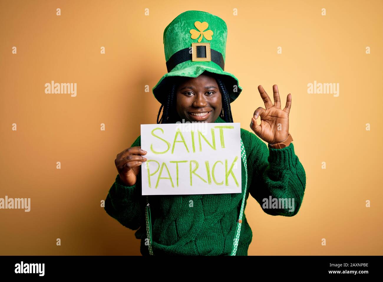 Plus size african american woman wearing green hat holding banner on ...