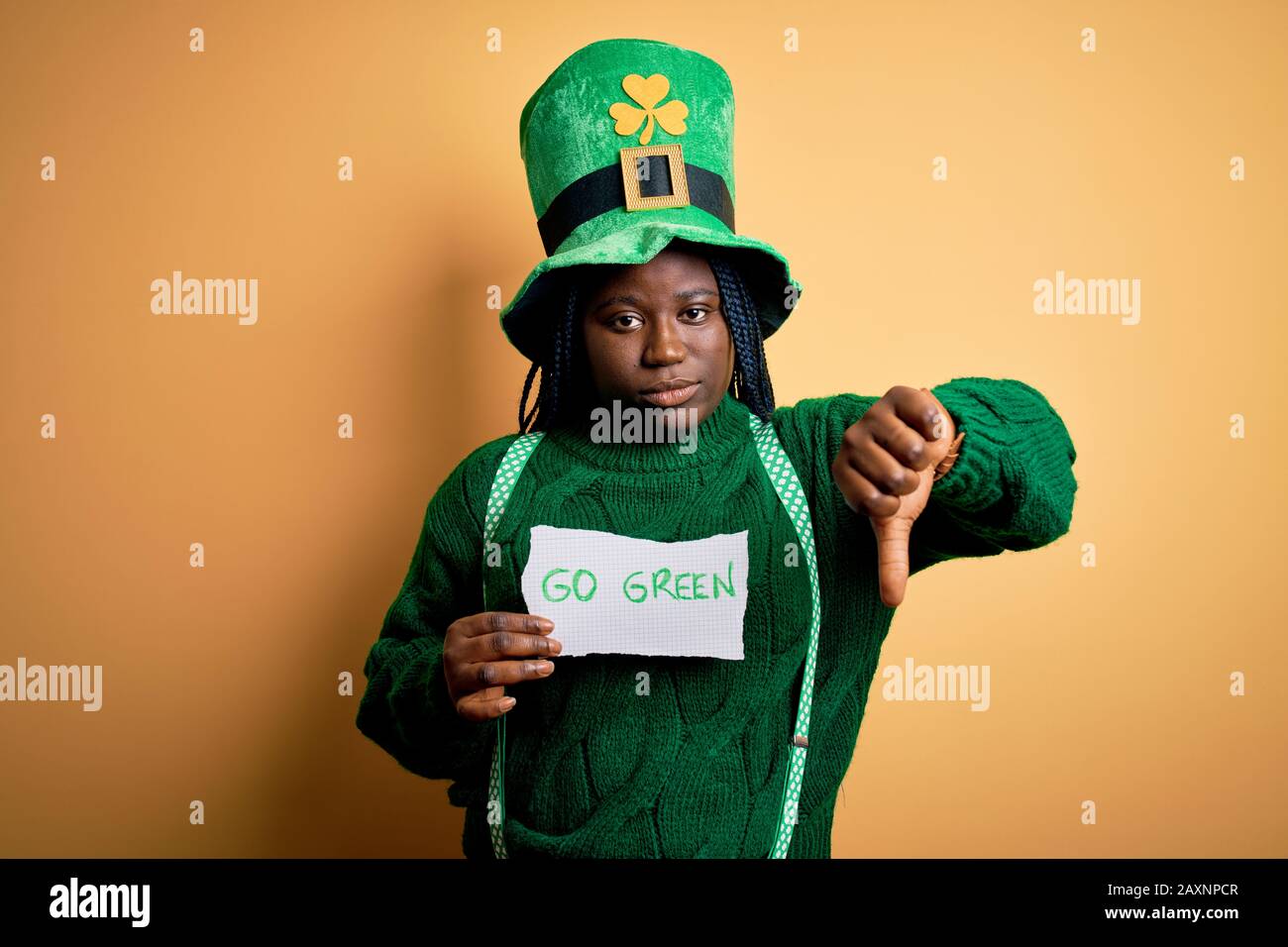 Plus size african american woman wearing green hat holding paper on ...