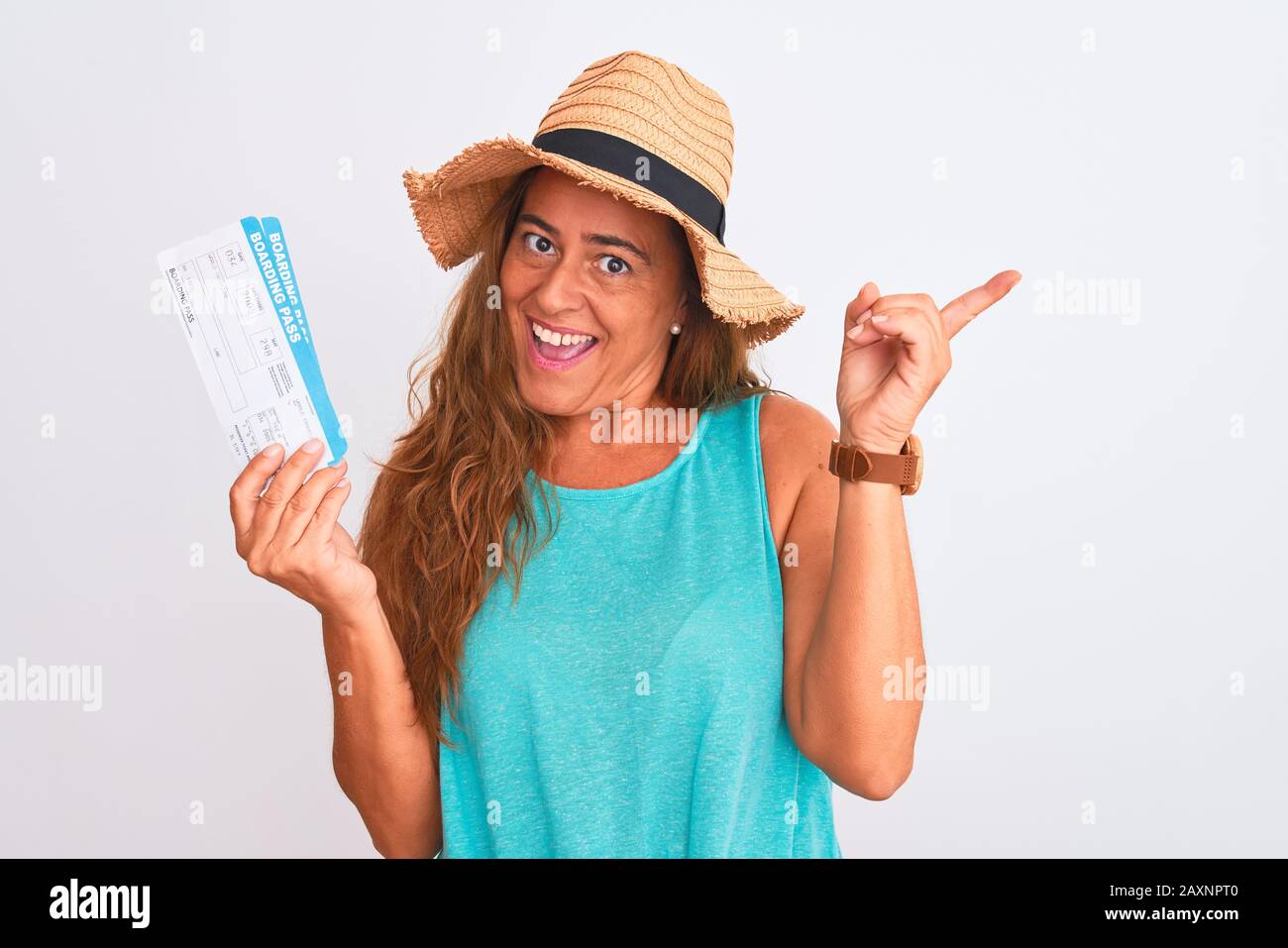 Middle age mature tourist woman holding boarding pass over isolated ...