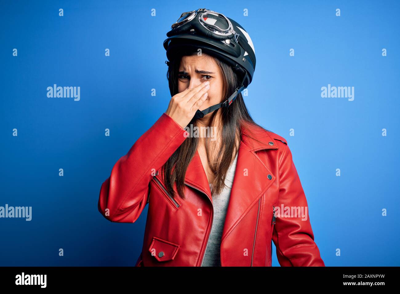 Young beautiful brunette motorcycliste woman wearing motorcycle helmet ...