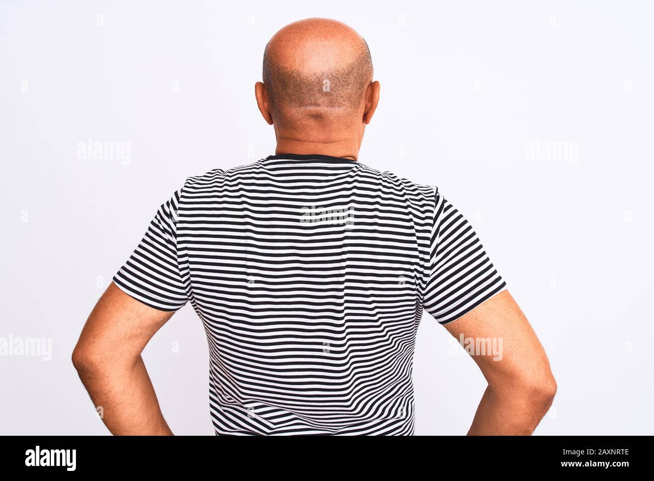 Middle age handsome man wearing striped navy t-shirt over isolated ...