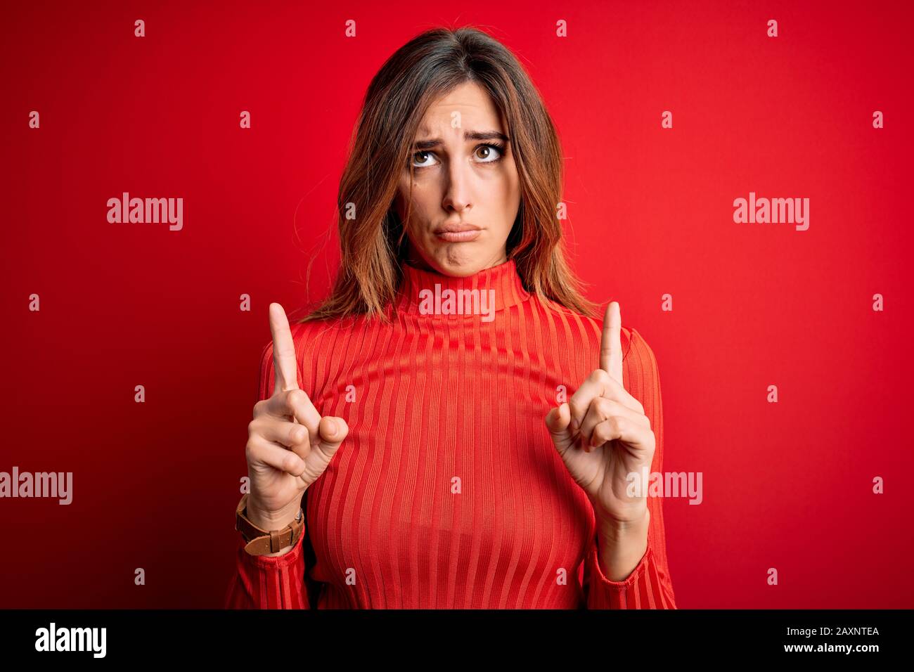 Young beautiful brunette woman wearing casual turtleneck sweater over ...