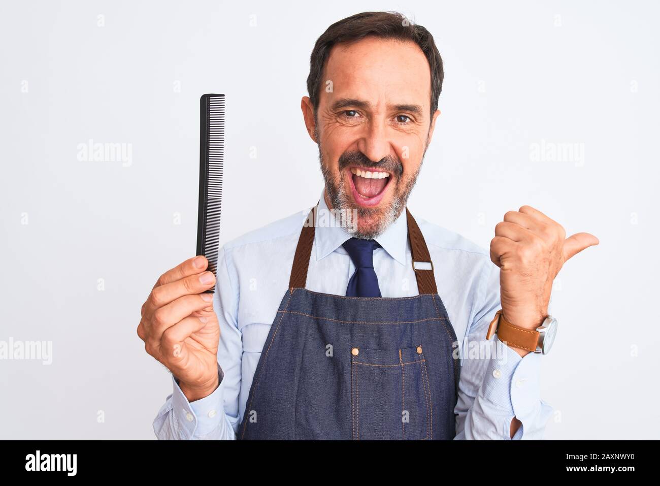 Middle age barber man wearing apron holding hair comb over isolated ...