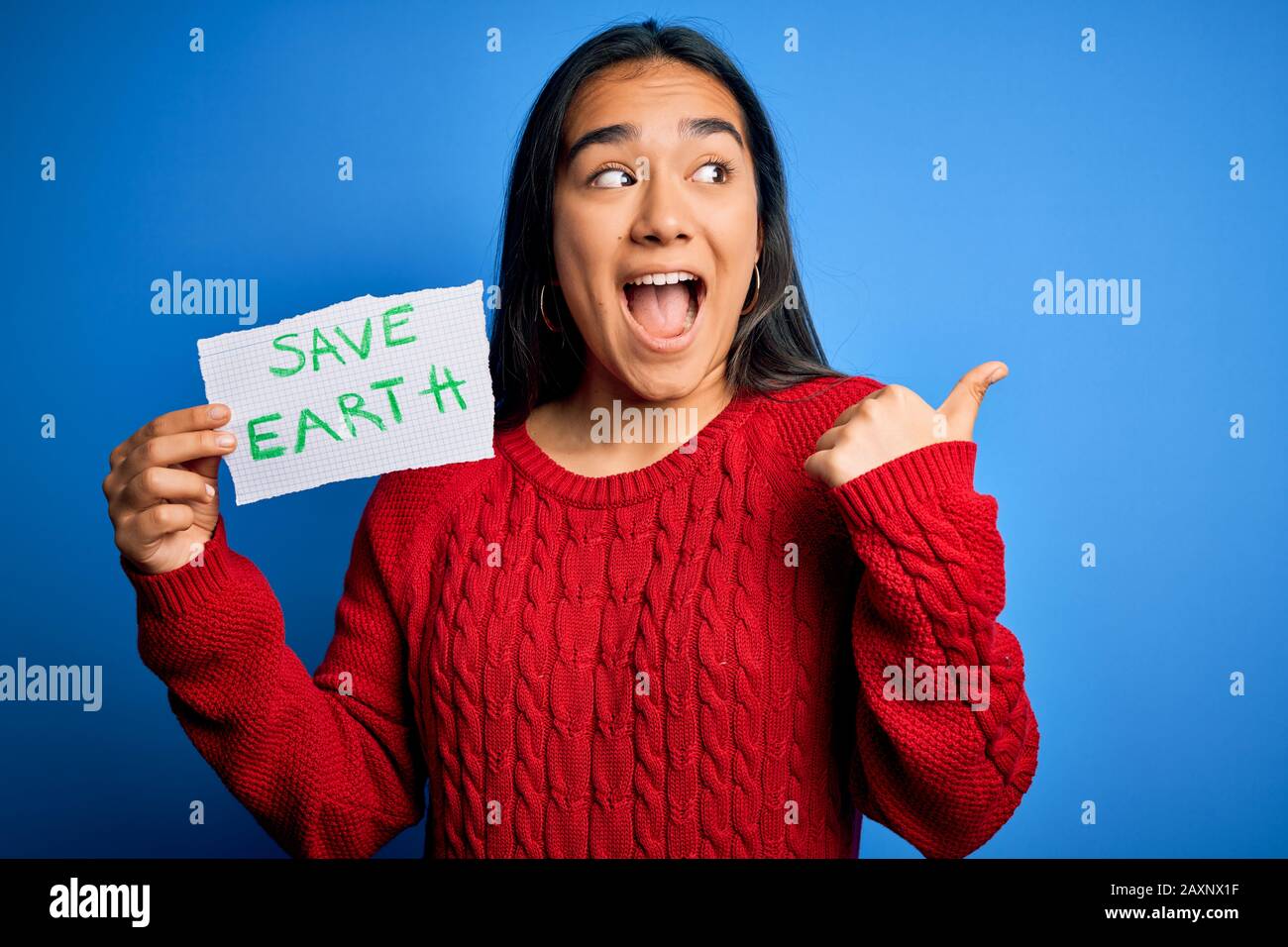 Young beautiful asian woman holding paper asking for save earth and ...