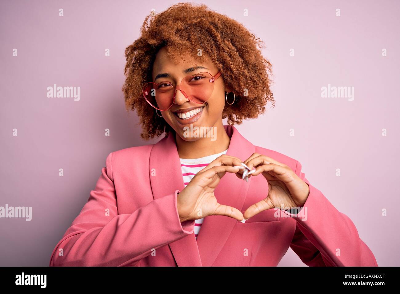 Young African American afro woman with curly hair wearing funny hearts ...