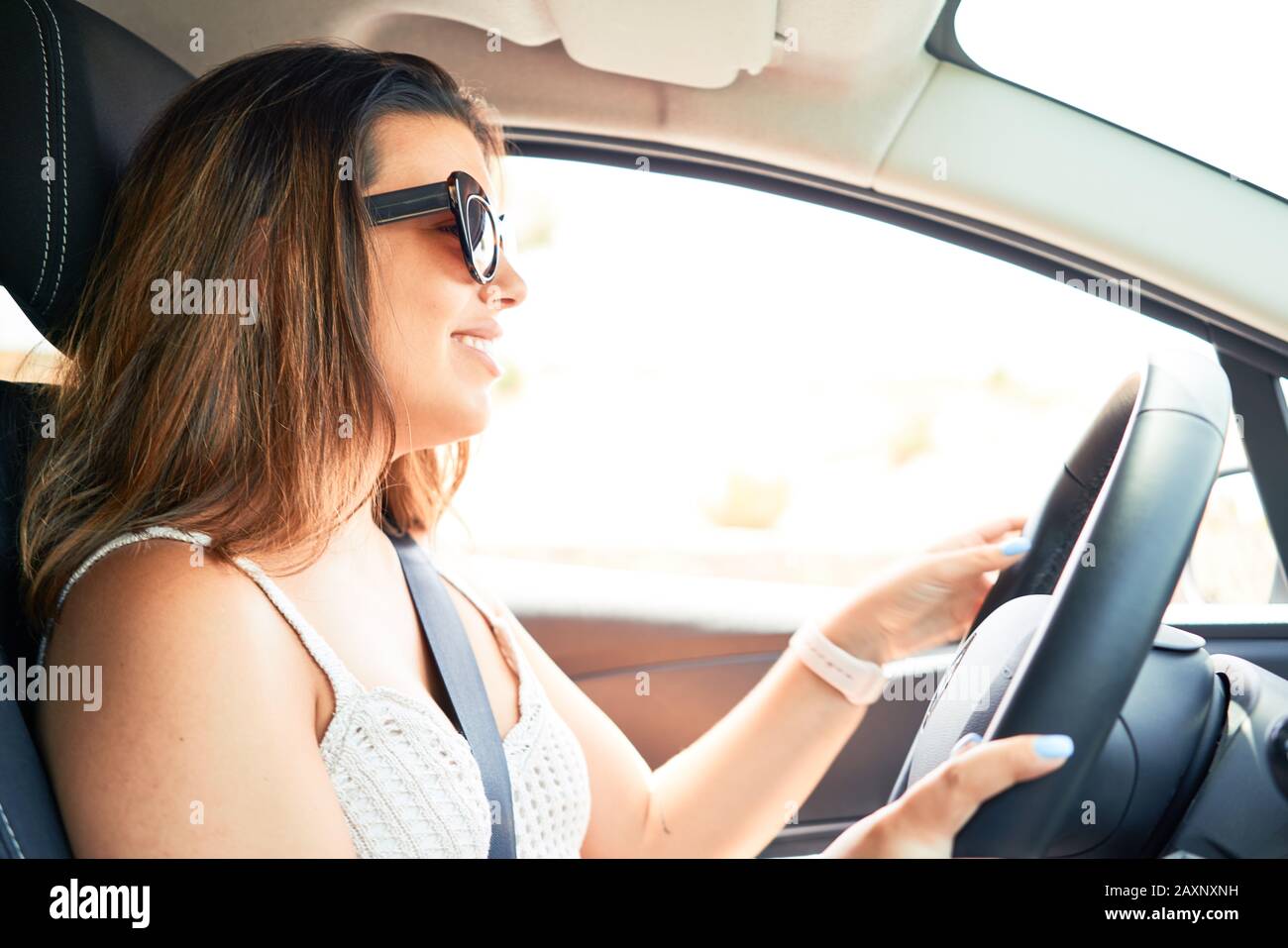Young driver woman driving car Stock Photo - Alamy