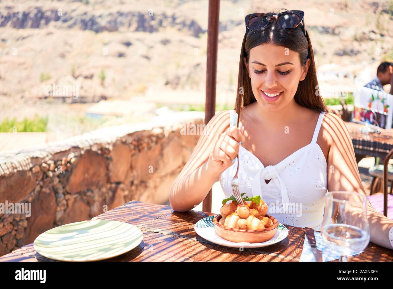 Young beautiful woman sitting at restaurant enjoying summer vacation ...