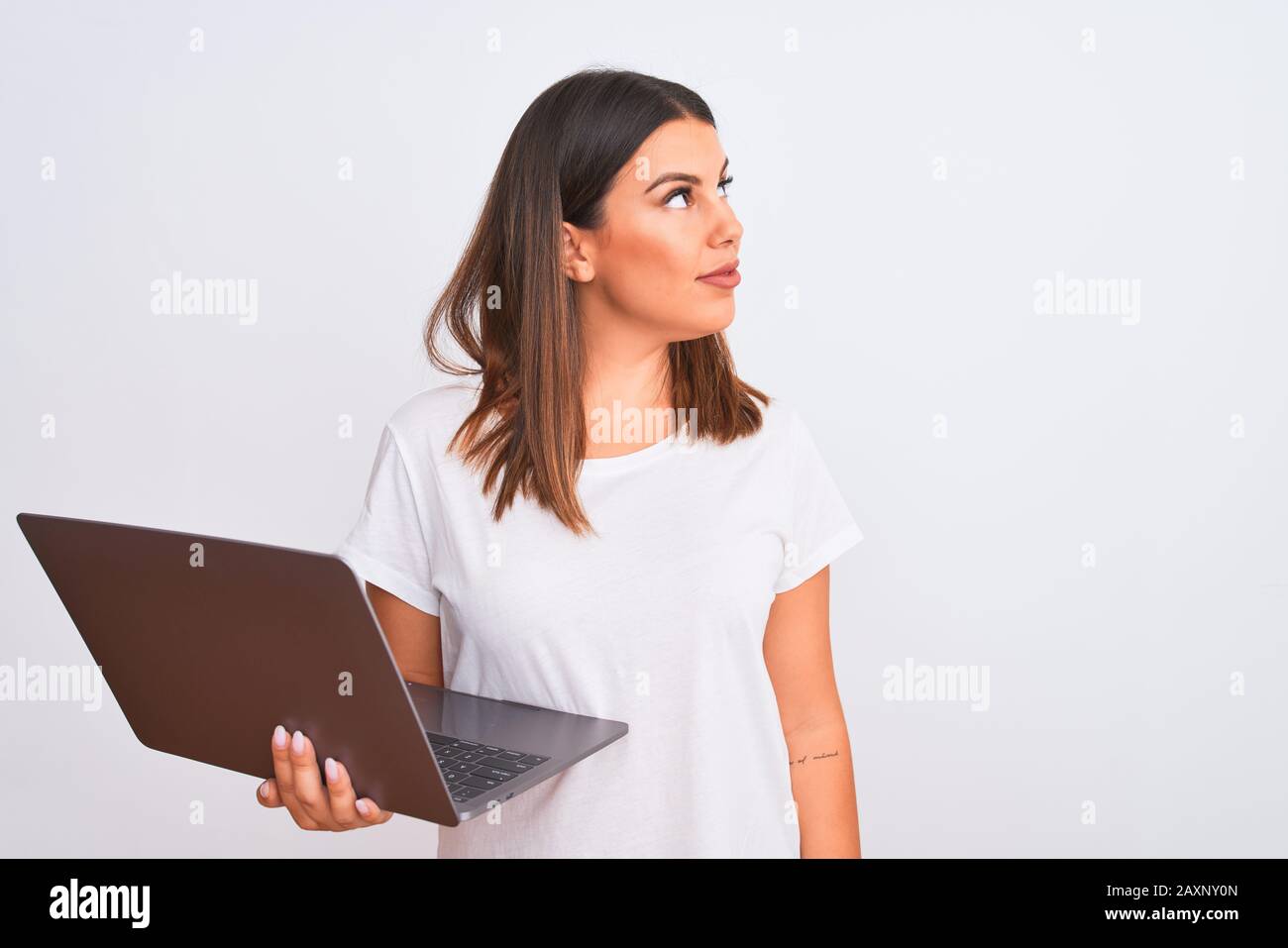 Beautiful young woman working using computer laptop over white ...