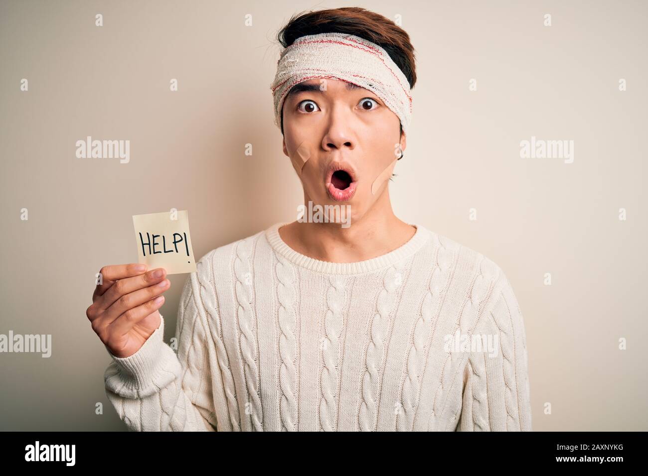 Young handsome chinese man injured for accident wearing bandage on head ...