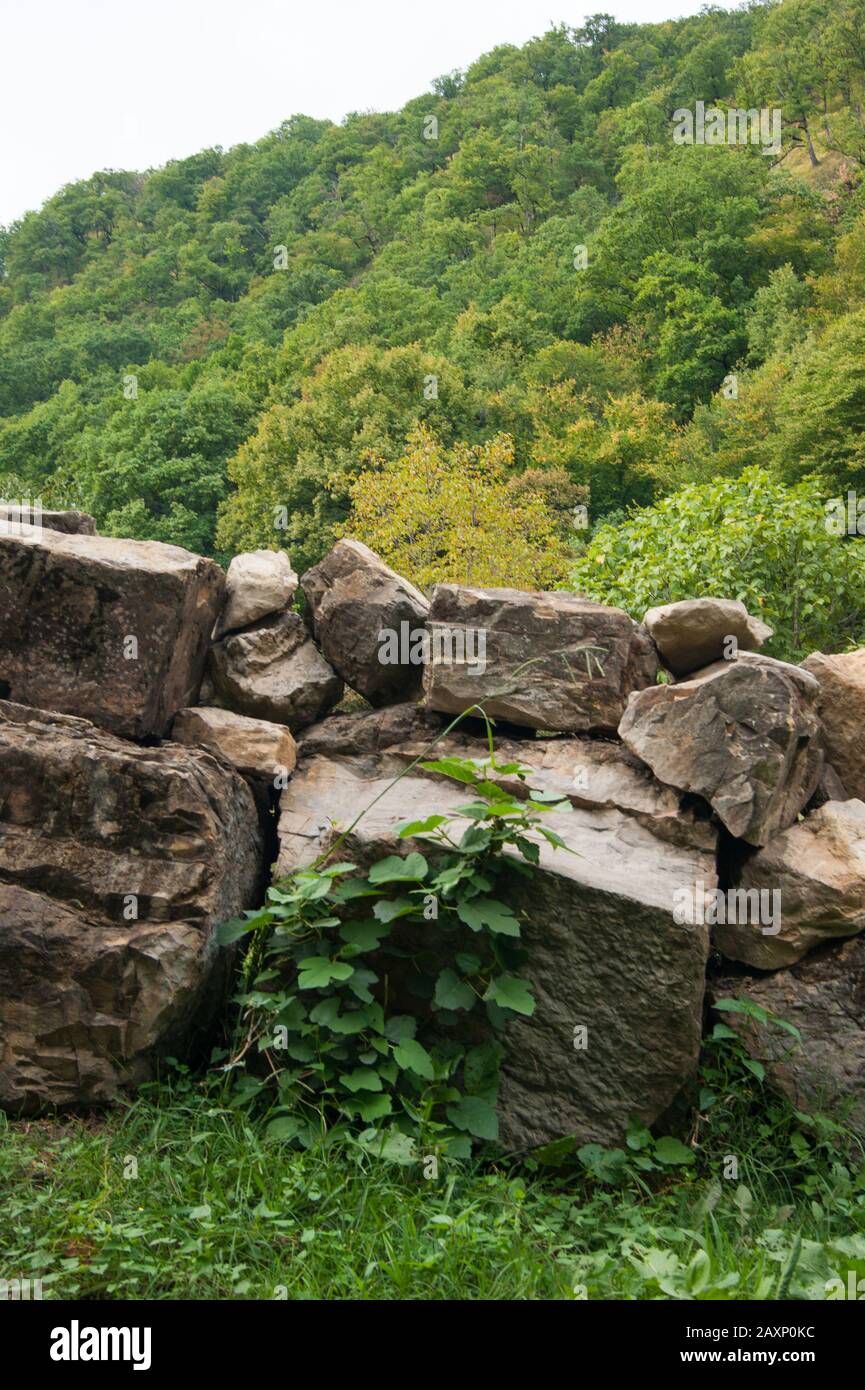 A fence of huge stone boulders laid on top of each other on a mountain ...