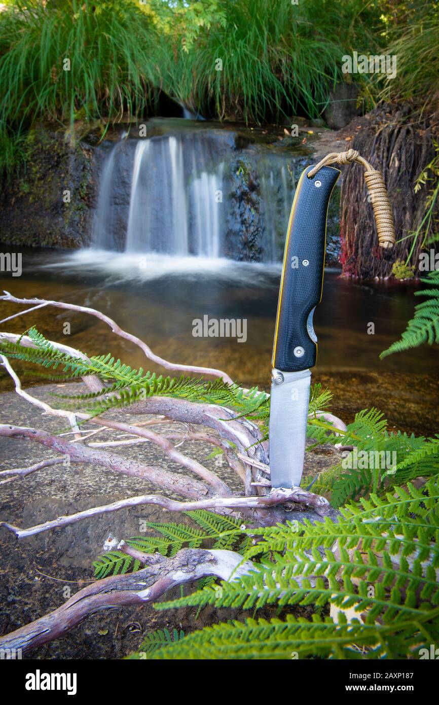 knife for bushcraft and survival in the wild near to a waterfall Stock ...