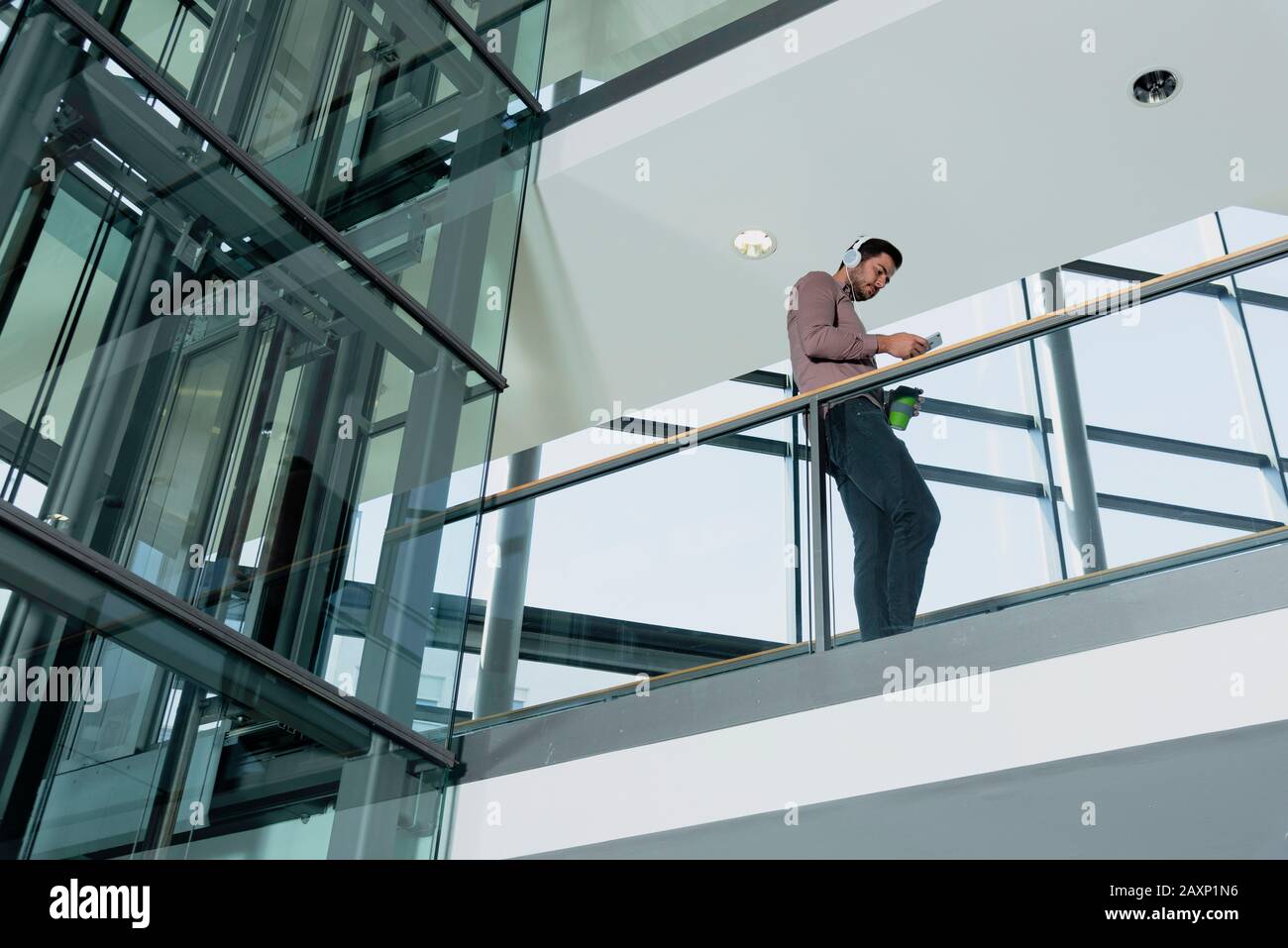 Young man in modern office building has a break Stock Photo - Alamy