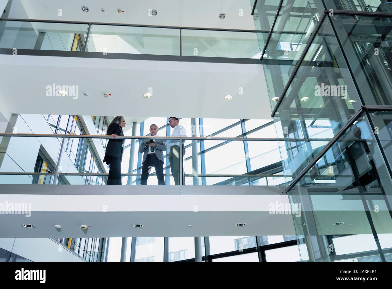 Three business people at a meeting in modern office building Stock ...