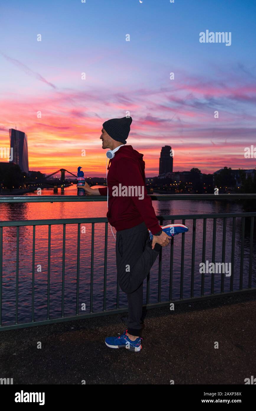 Man stretching with hand at balustrade hi-res stock photography and ...