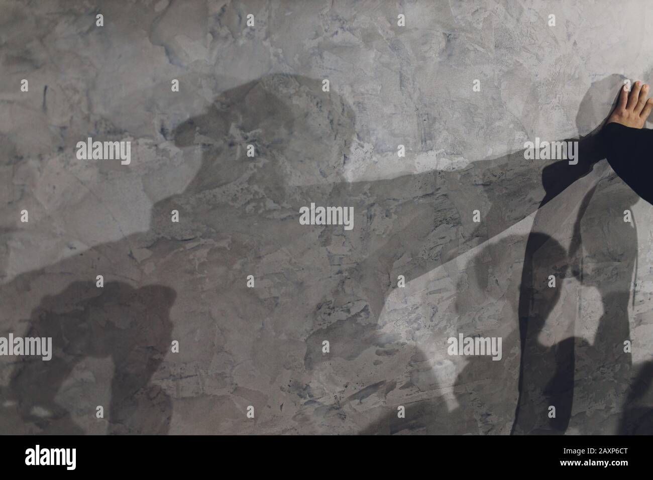 group of human shadows on the stone wall at sunset time Stock Photo - Alamy