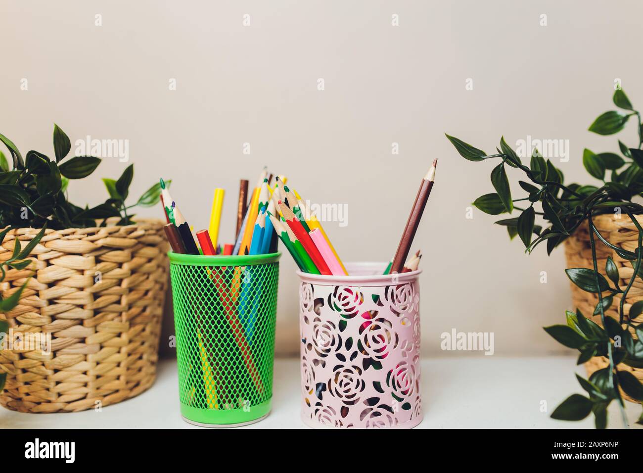 Colored pencils, brushes for drawing, eraser and ruler in a transparent ...