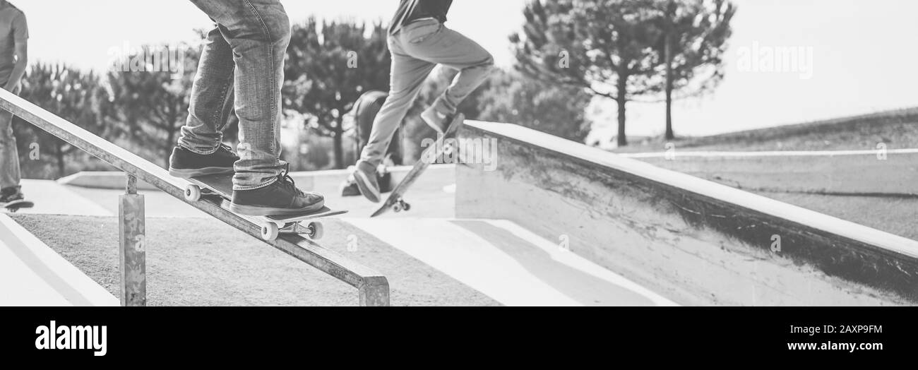 Group of skaters friends performing trick in pubblic park - Young men ...