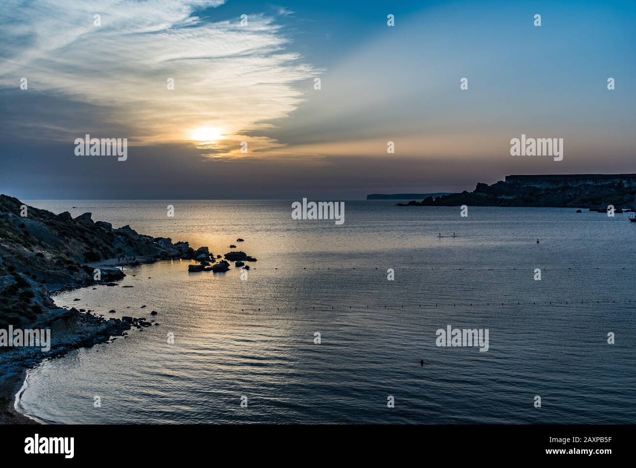 Spectacular sunset in the bay area of Malta with sun rays reflecting on ...
