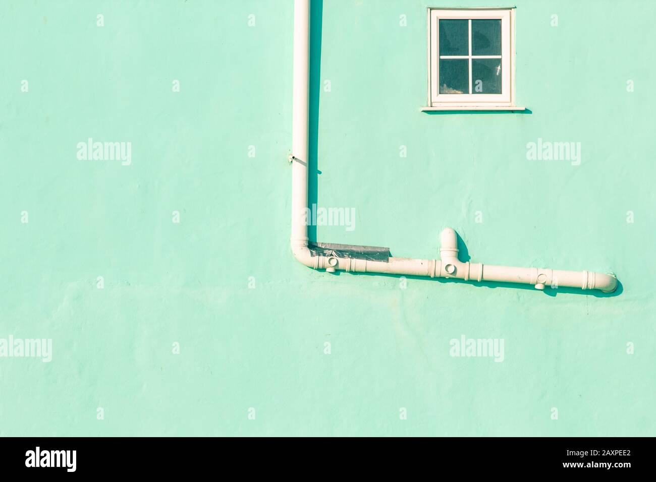 A pipe installation on the exterior wall of a house in England Stock ...