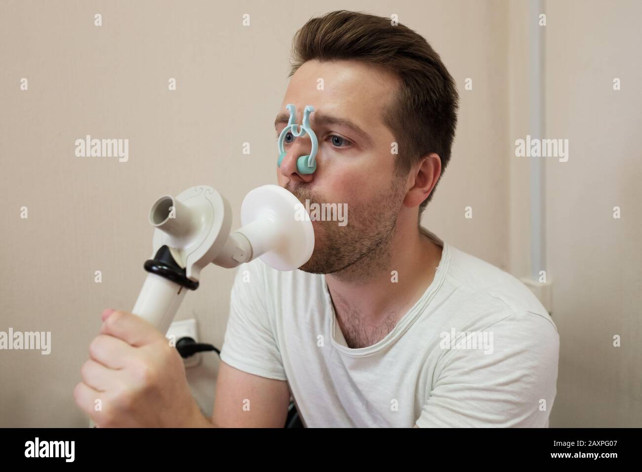 Young man testing breathing function by spirometry having health ...