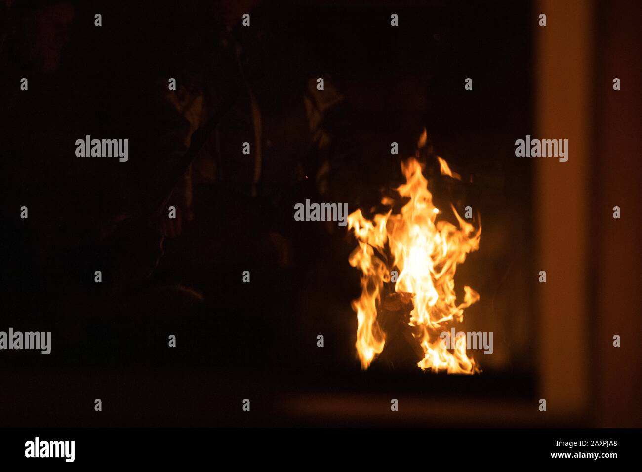 Reflection campfire in window Stock Photo - Alamy