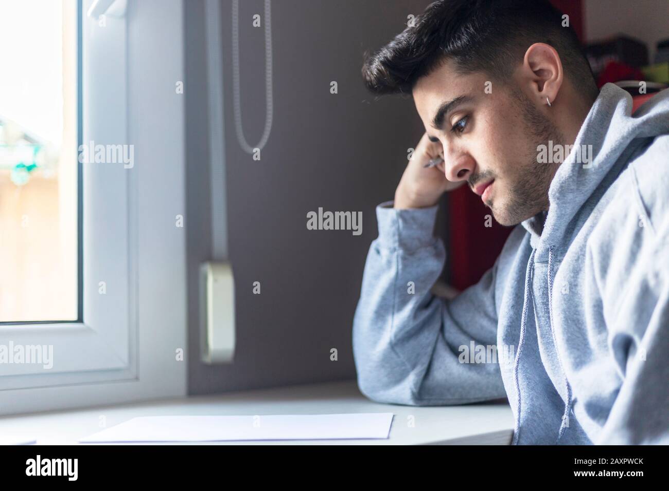 Student writing notes in a notebook Stock Photo - Alamy