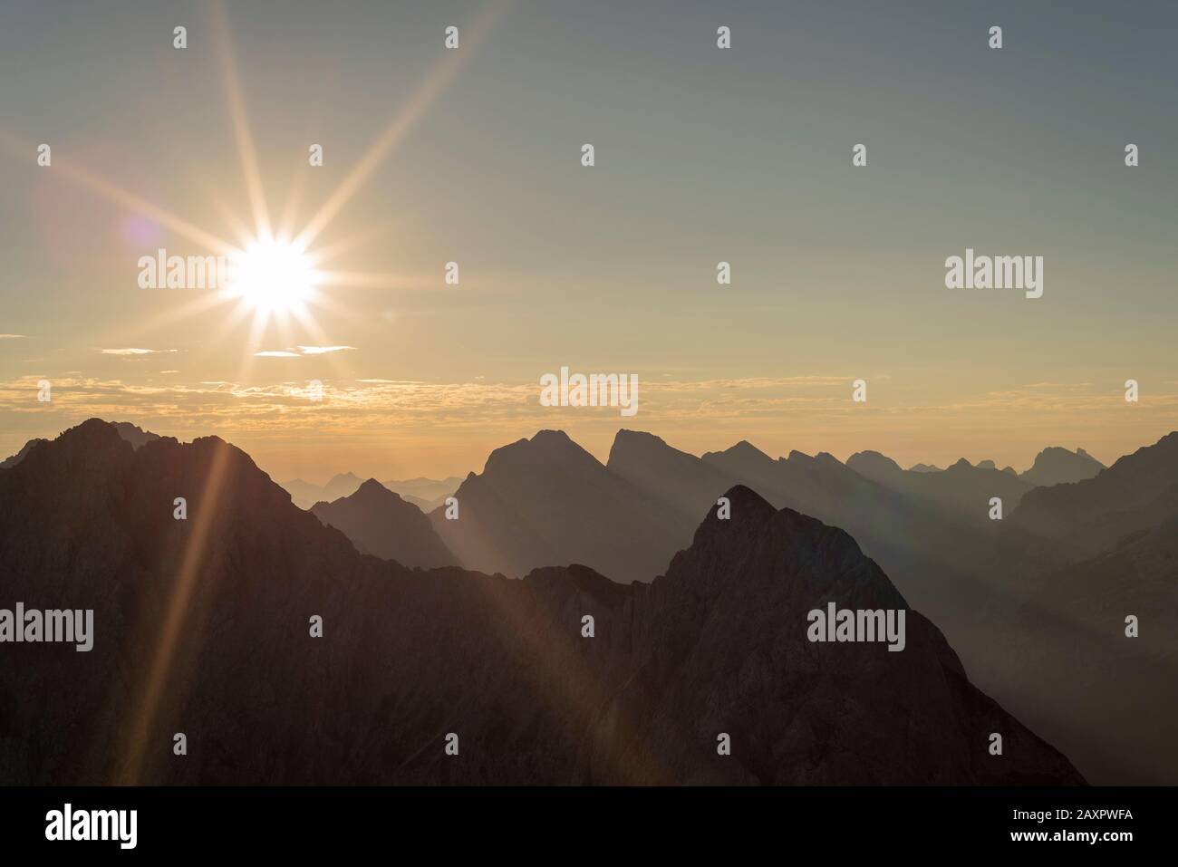 Sun rising from behind the mountains hi-res stock photography and ...