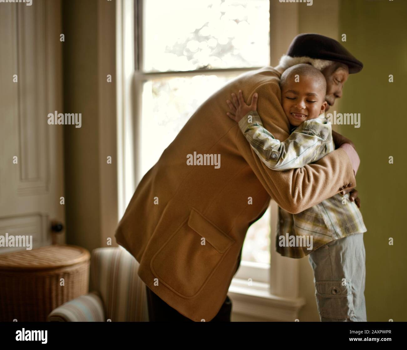 Grandfather and grandson hugging each other Stock Photo - Alamy