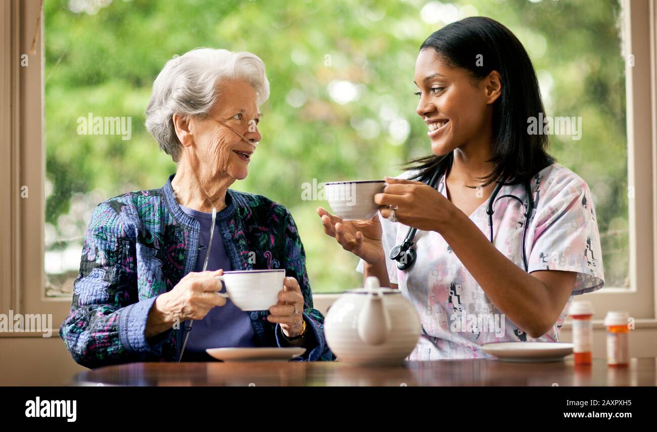Female nurse explaining how to take medication to a senior patient ...