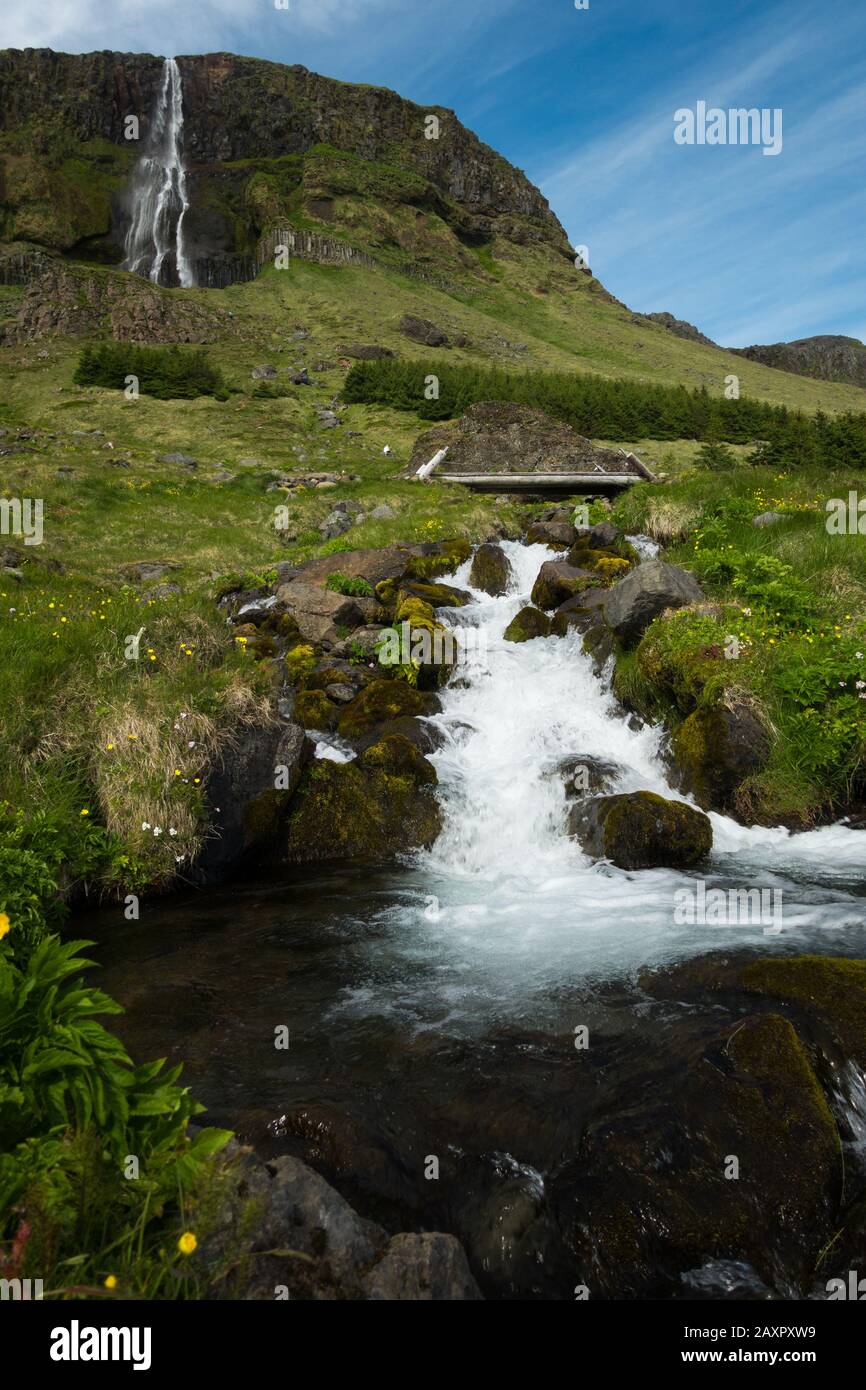 Beautiful Bjarnarfoss waterfall atop green meadows on Snaefellsnes ...
