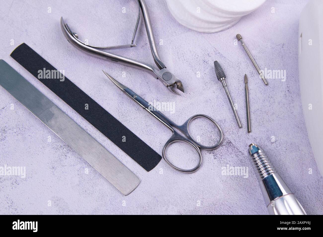 Set of cosmetic tools for manicure and pedicure on a concrete ...