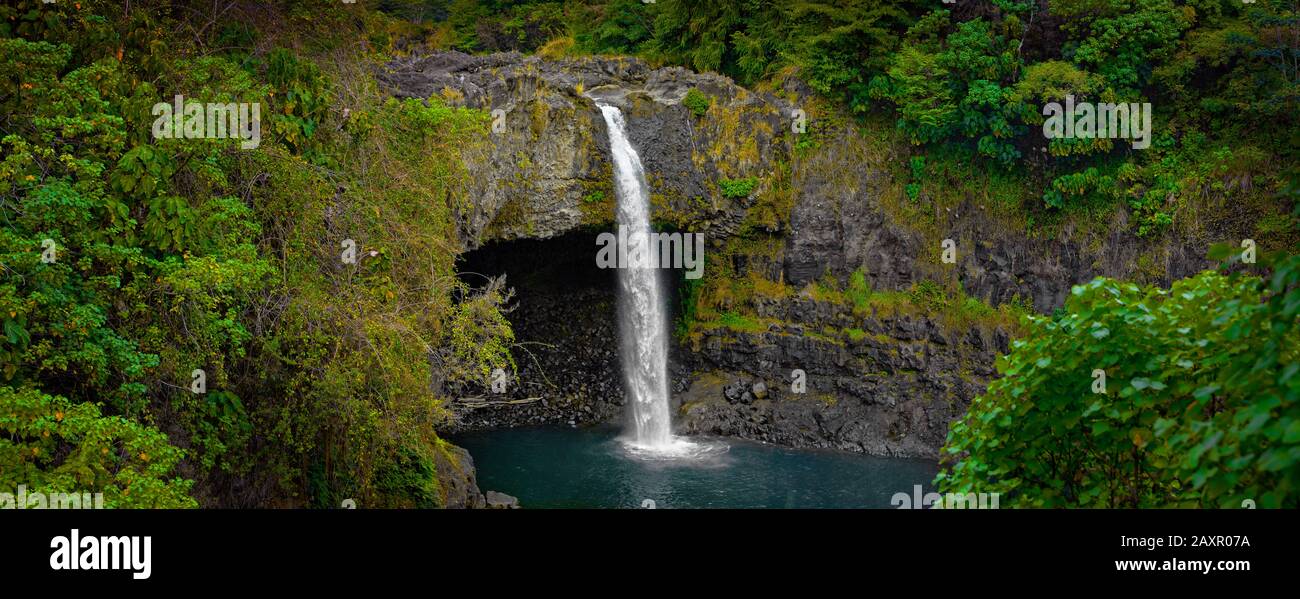 Waterfall cascading over a rock face into water below Stock Photo - Alamy