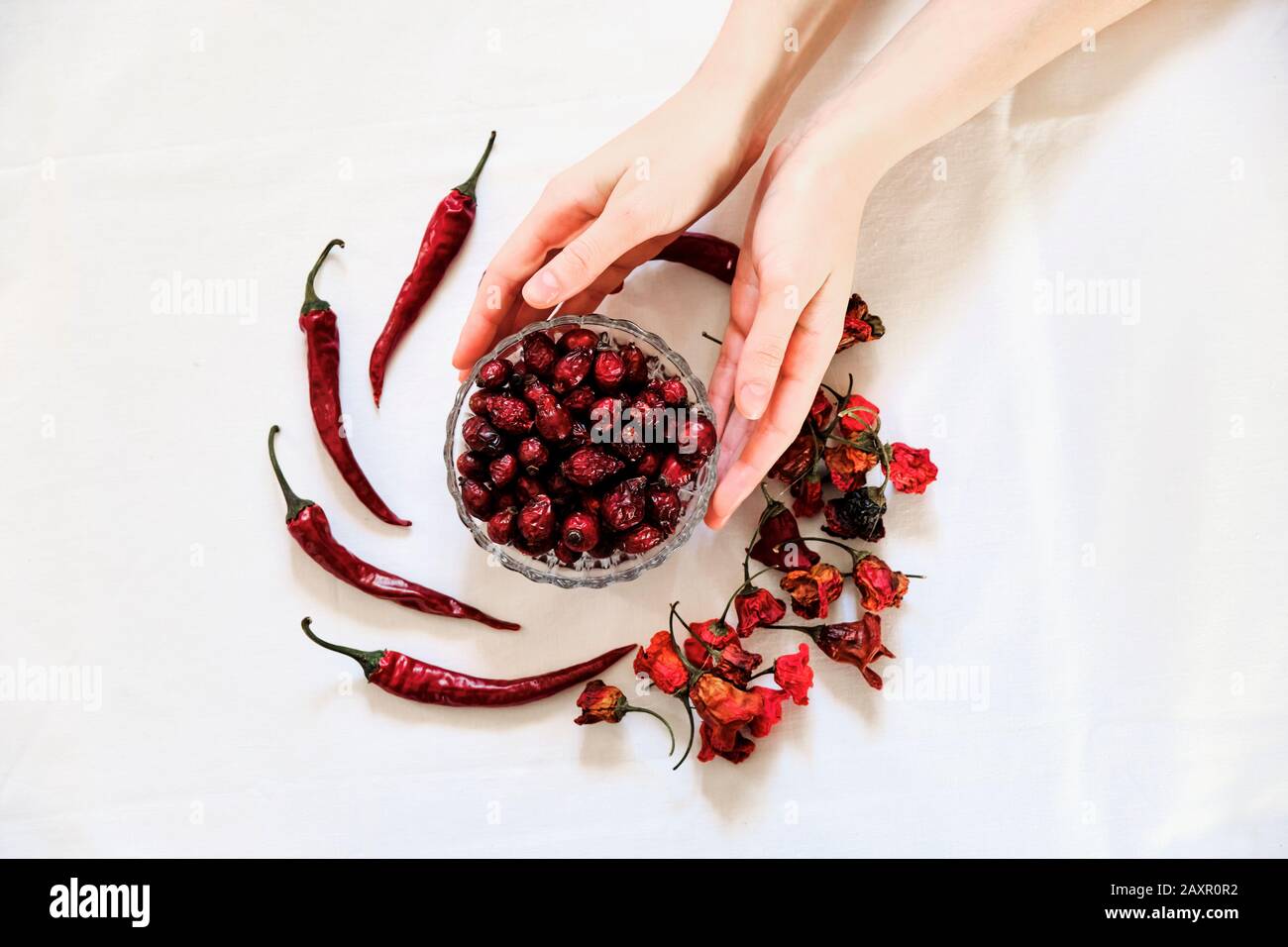 Dried red chili peppers and rose hips (berry) on white background Stock ...