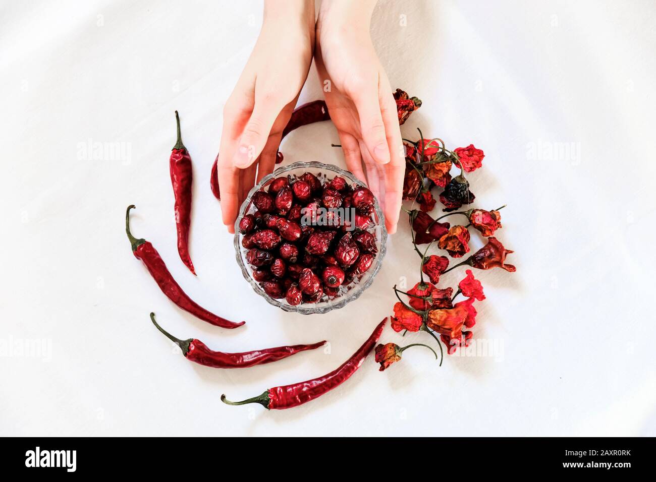 Dried red chili peppers and rose hips (berry) on white background Stock ...