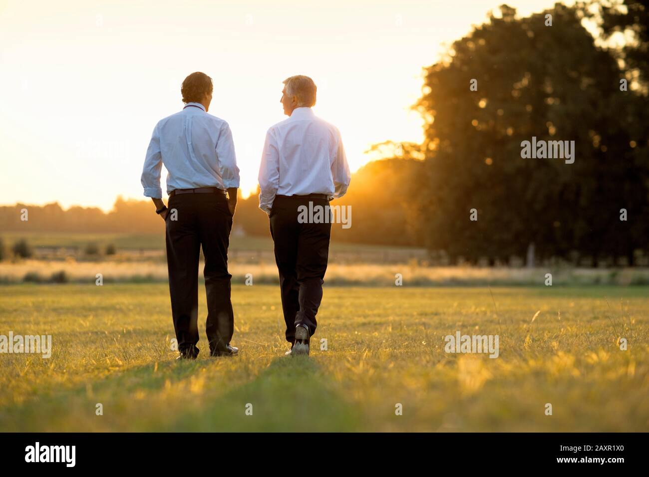 Two men walking through a garden hi-res stock photography and images ...